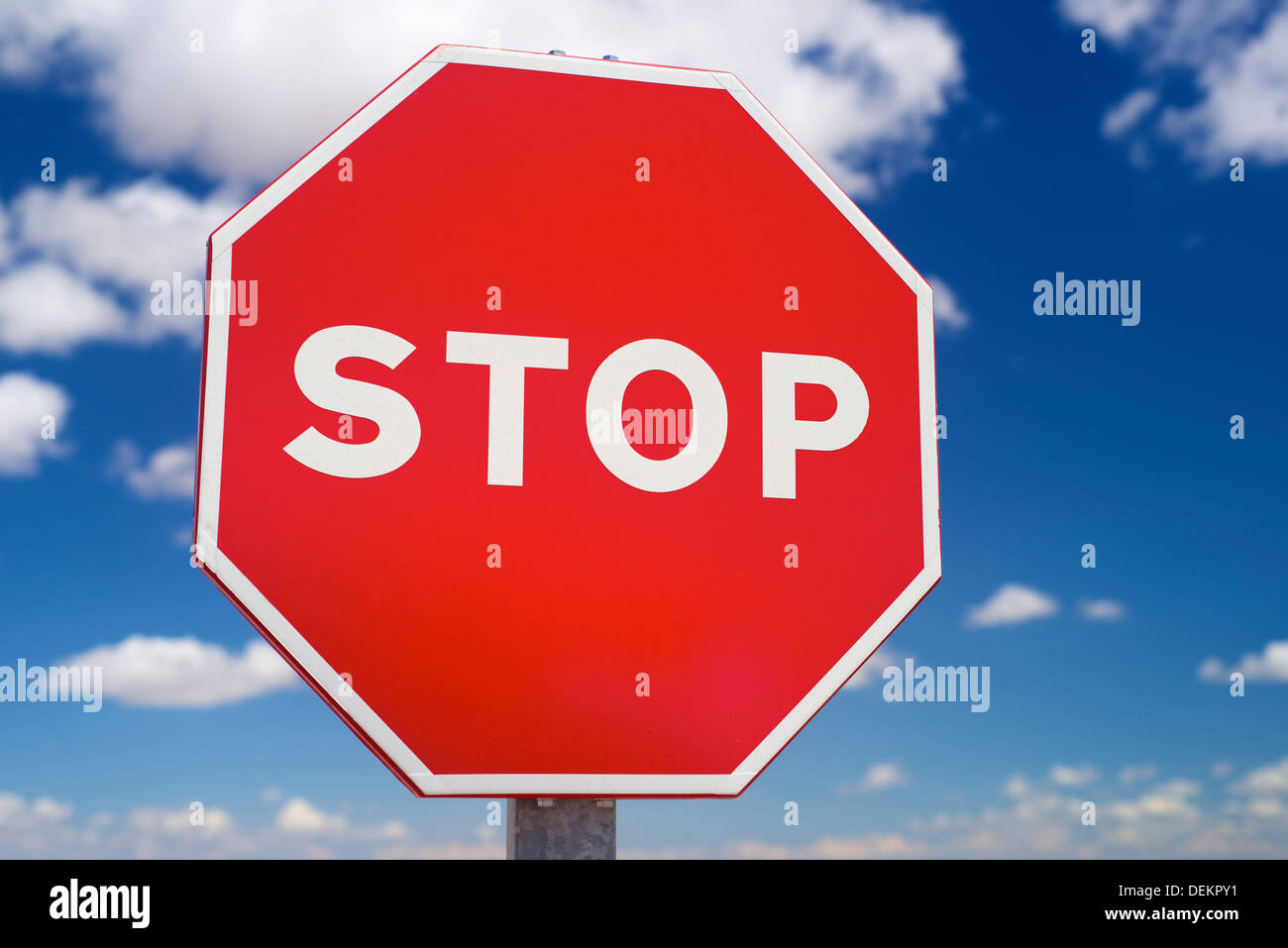 Stop sign and blue sky with white clouds Stock Photo - Alamy