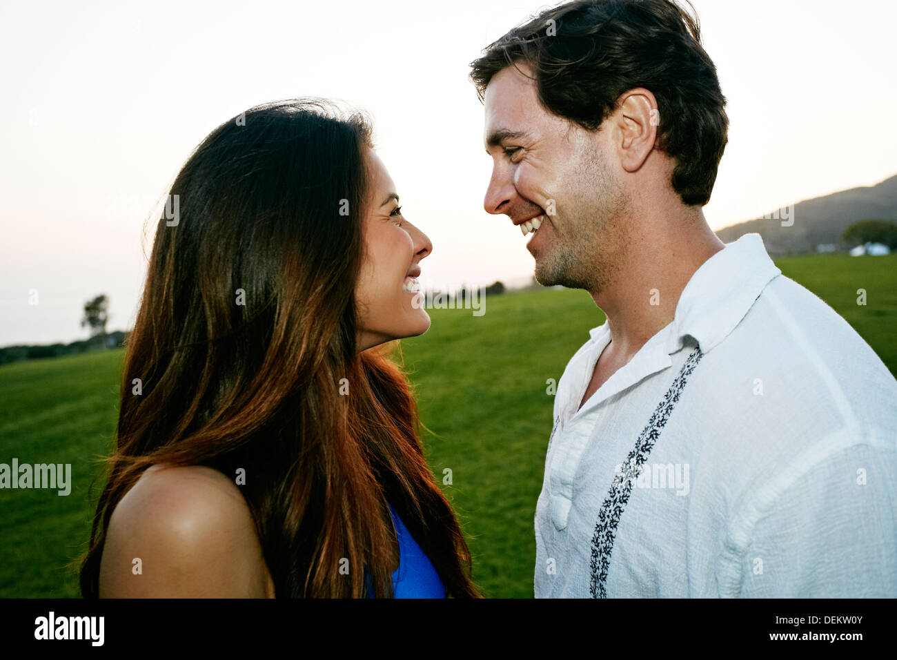 Couple smiling together in park Stock Photo - Alamy