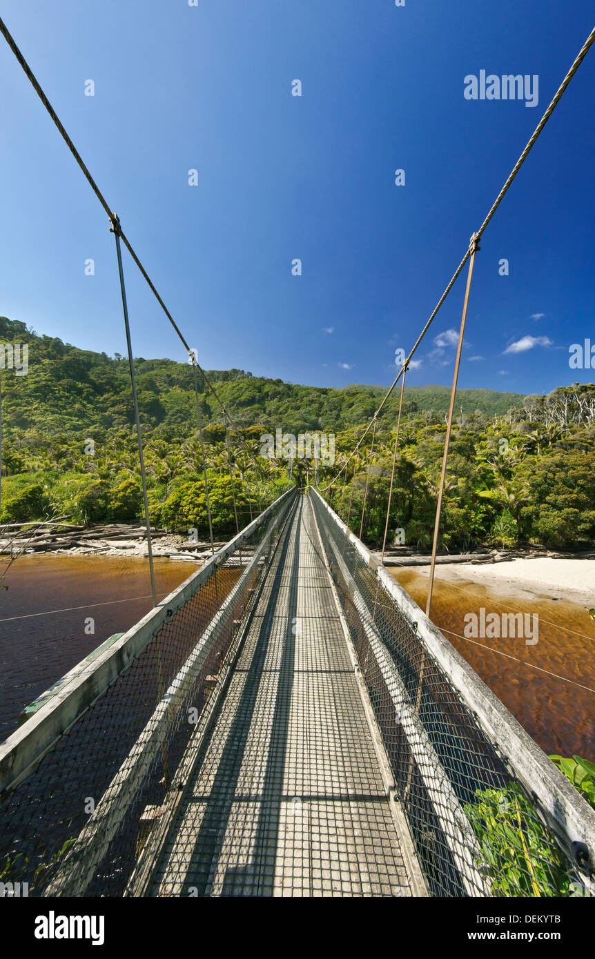 Suspension bridge over tropical beach Stock Photo - Alamy