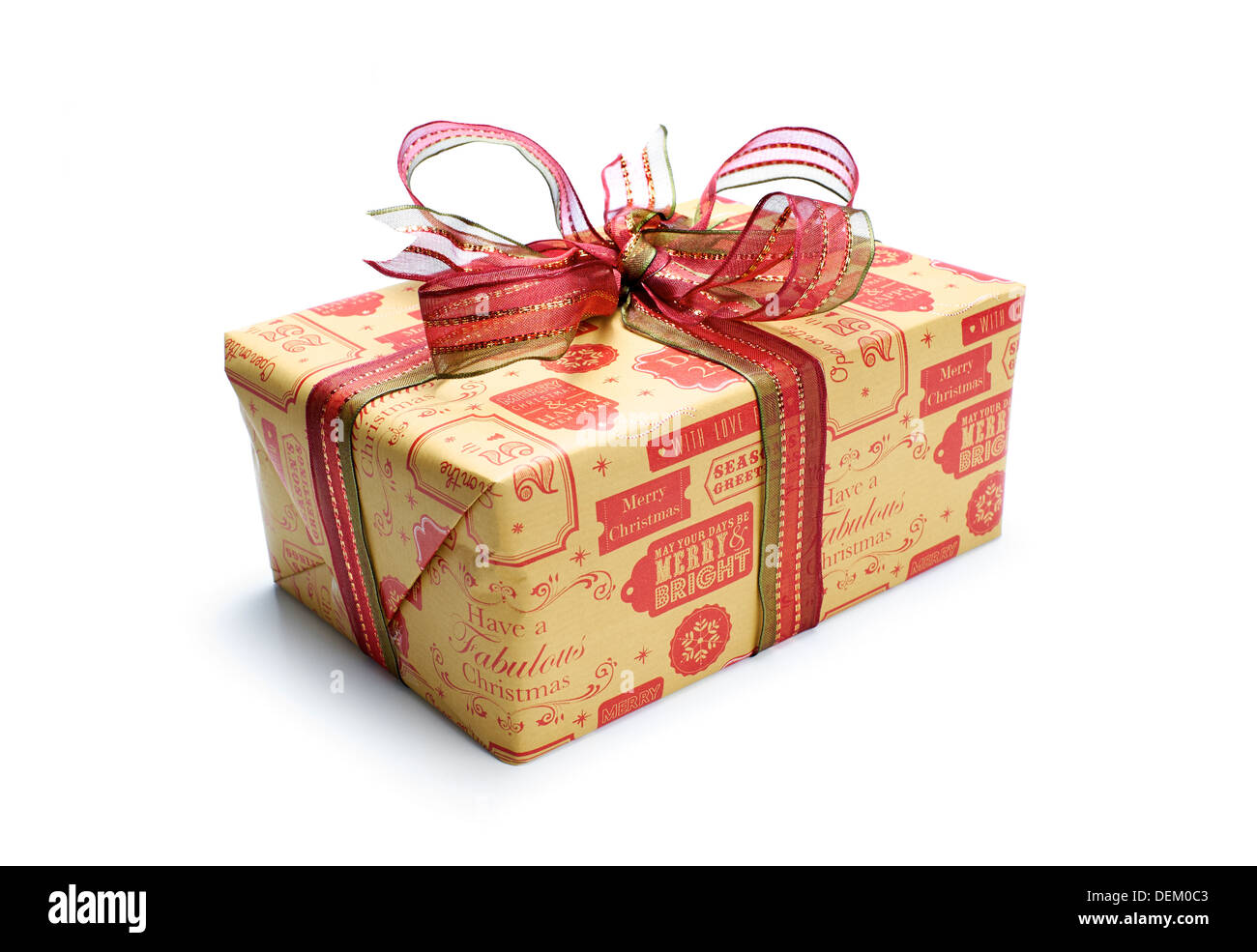 A wrapped Christmas present with a colourful ribbon bow on a white ...