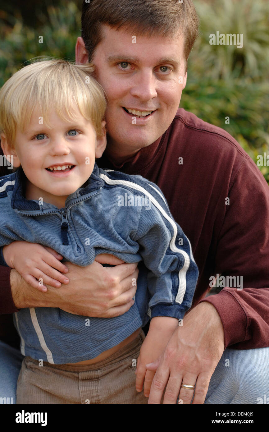 Father and son smiling outdoors Stock Photo - Alamy