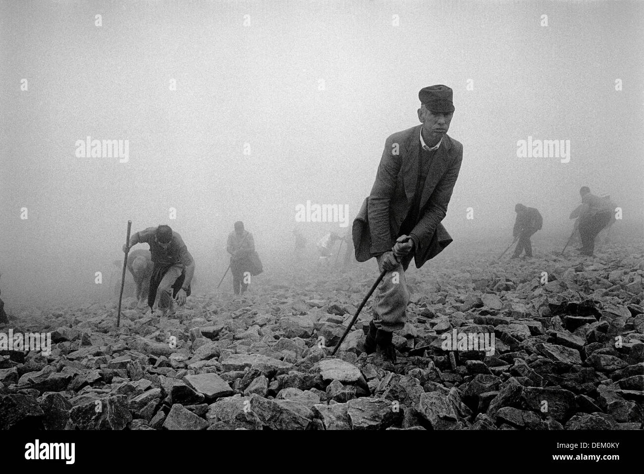 Pilgrim makes the ascent over rock and through mist and rain to the ...