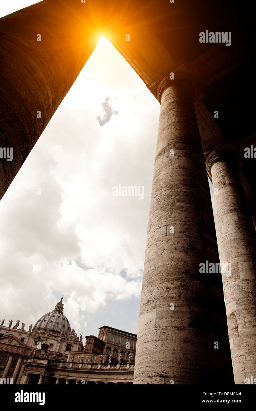Sun rising over columned buildings Stock Photo - Alamy
