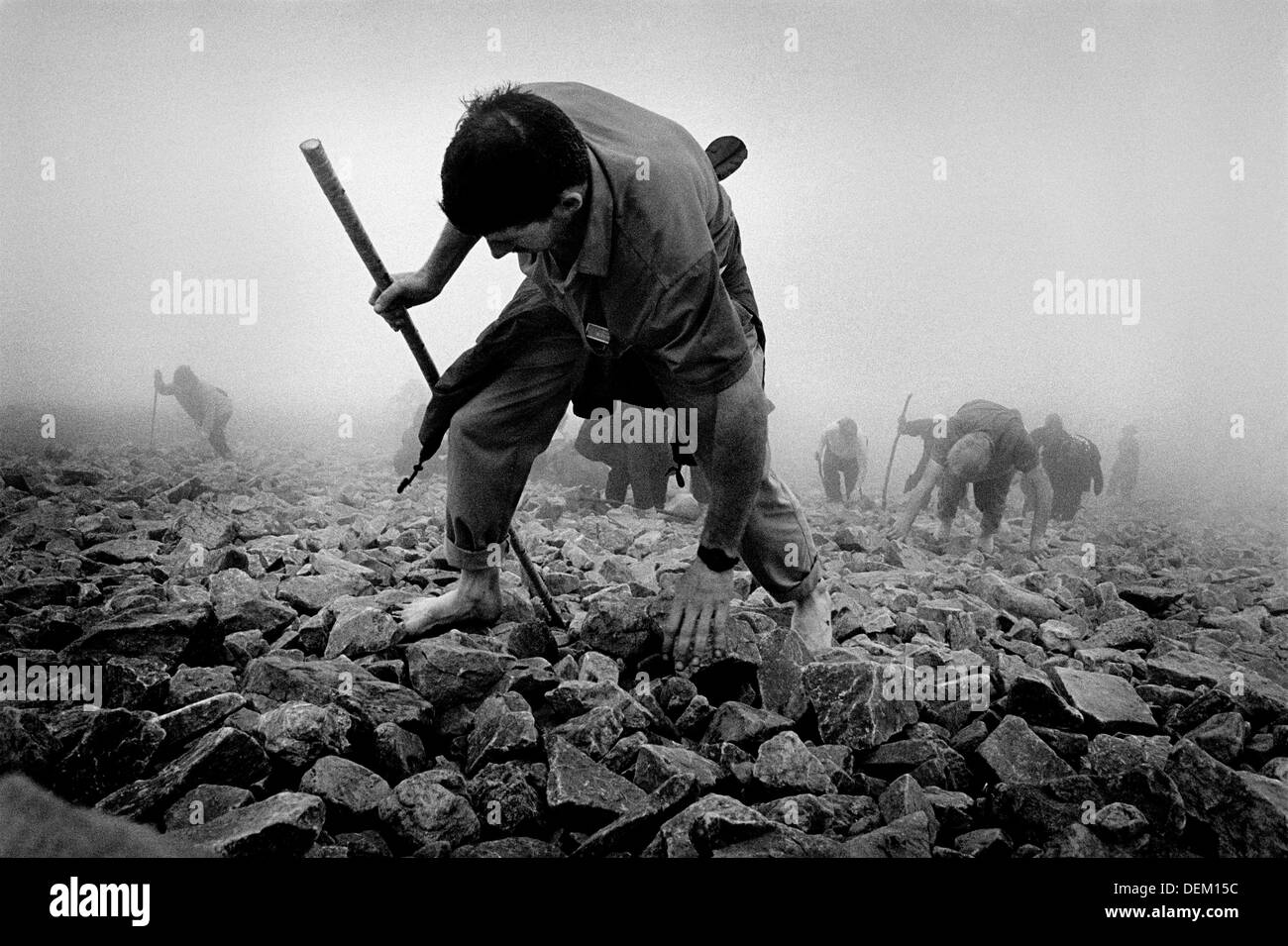 Pilgrim makes the ascent over rock and through mist and rain to the ...