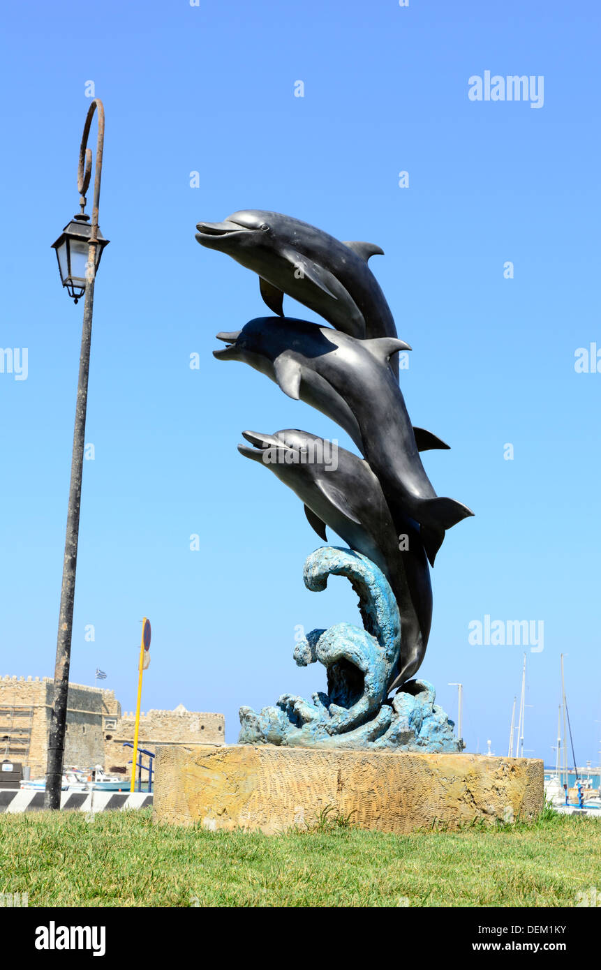Bronze sculpture of three dolphins in Heraklion - Crete, Greece Stock ...