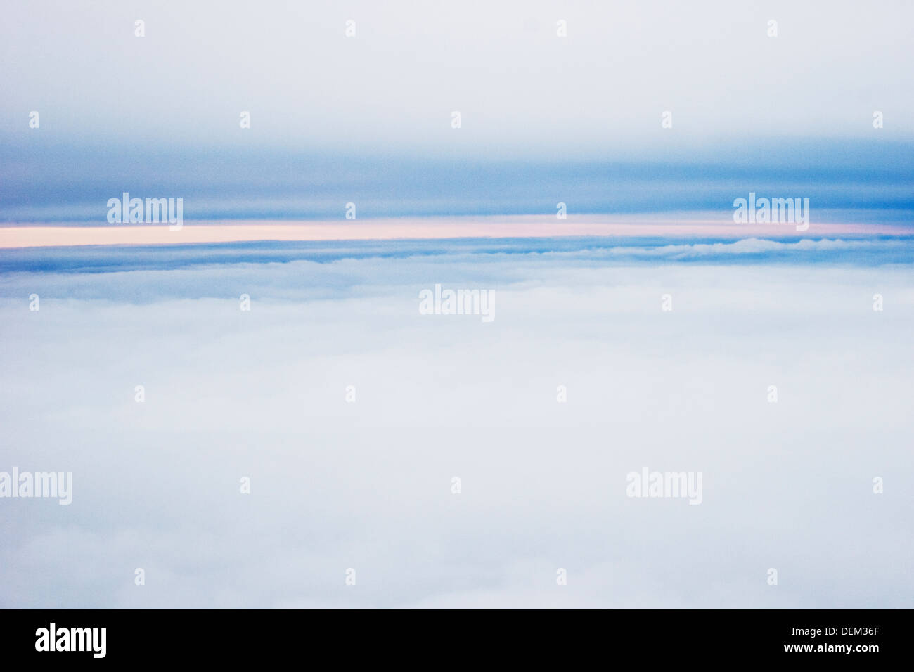 Band of Sky Between Two Layers of White Clouds Stock Photo - Alamy