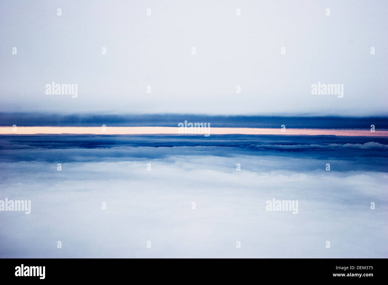 Band of Sky Between Two Layers of White Clouds Stock Photo - Alamy