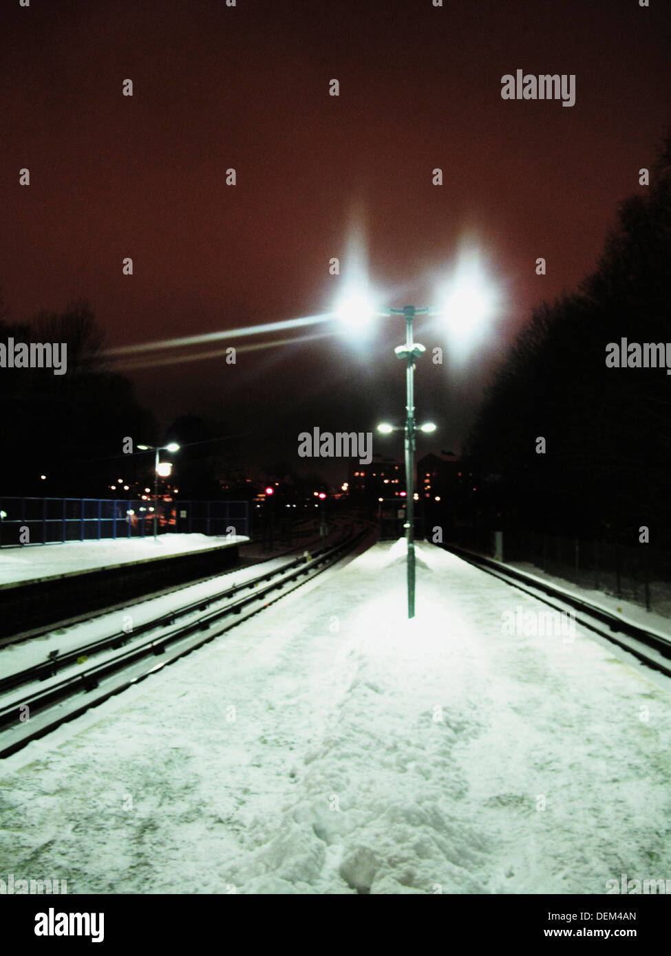 Train Platform and Tracks Covered in Snowy at Night Stock Photo - Alamy