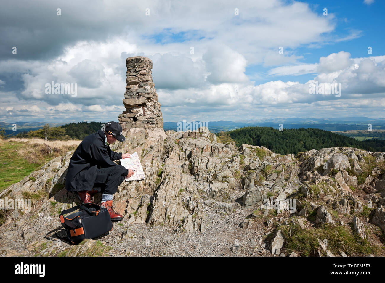 Man walker tourist holding compass and reading map of the Lake District ...