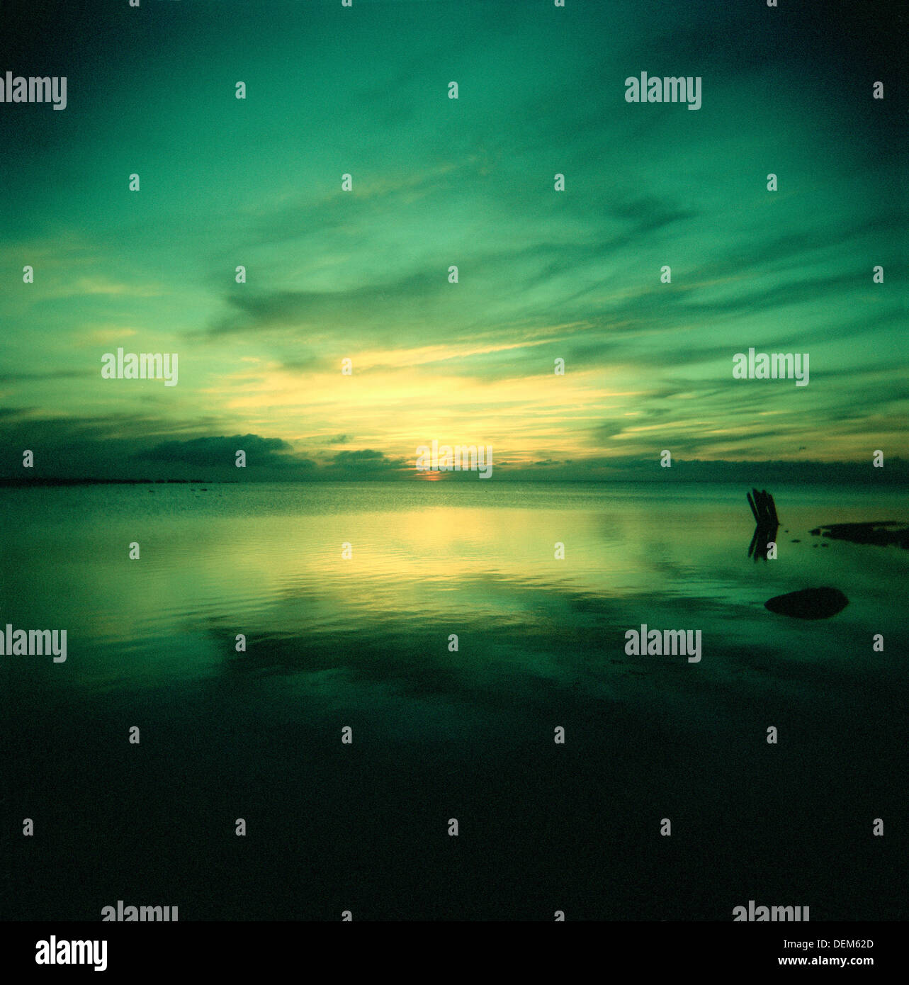 Dramatic Sunset Over Calm Water Stock Photo - Alamy