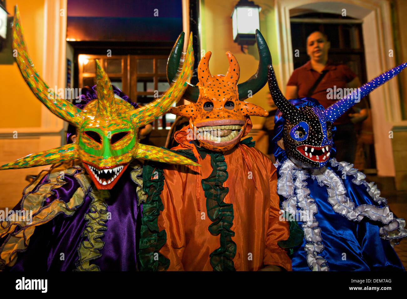 Costumed children dressed as vejigantes dance in the streets during ...