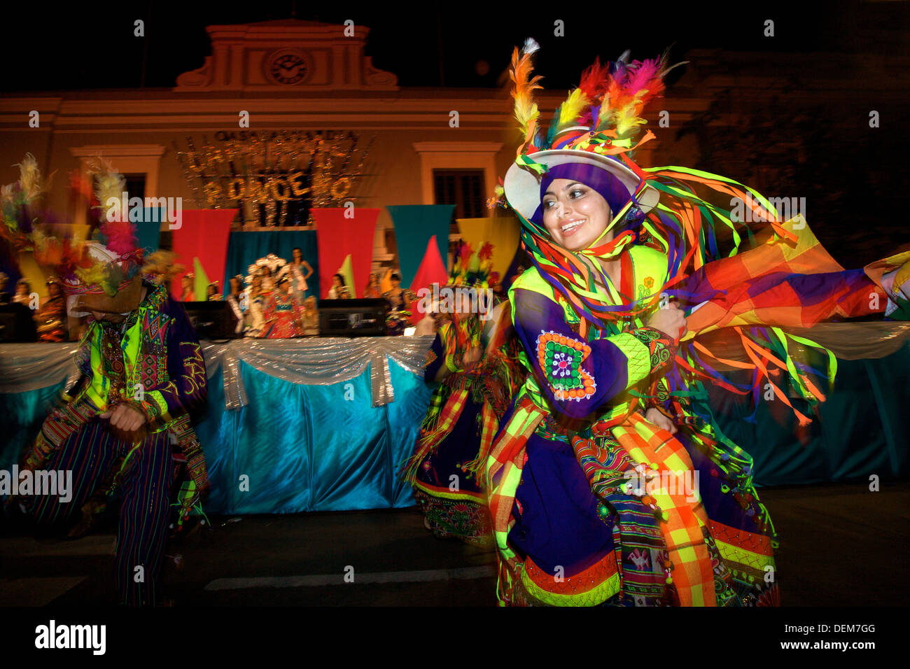 A costumed reveler from Bolivia dances in the streets during the ...