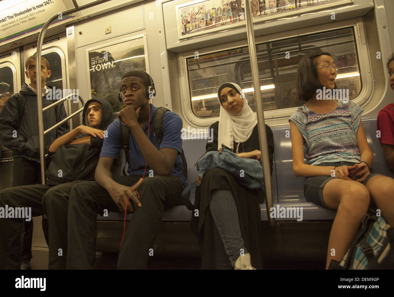 Multiethnic and cultural group of young people ride the New York City ...