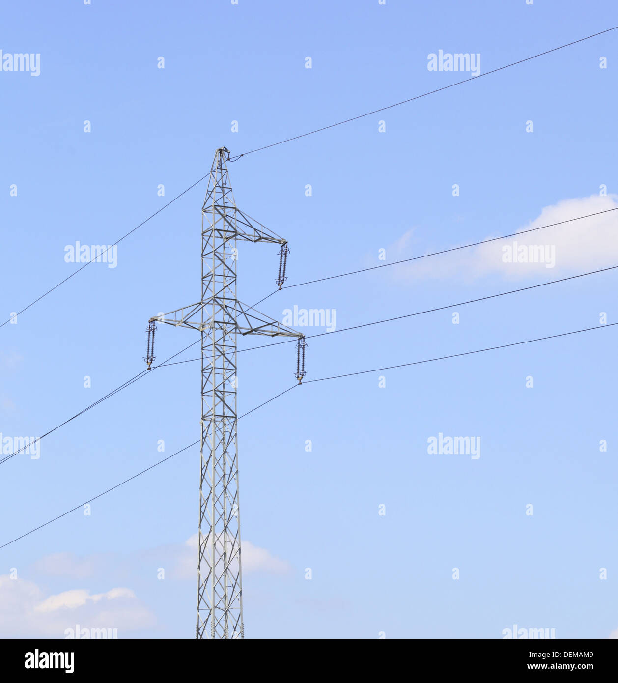 high-voltage wire tower electrical power lines and pylons against blue ...