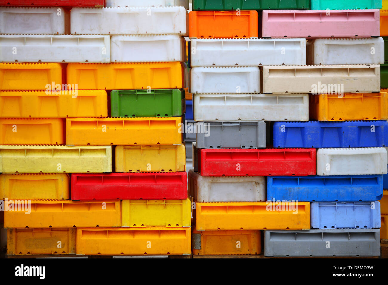 colorful boxes plastic crates background. Packing containers piles for ...