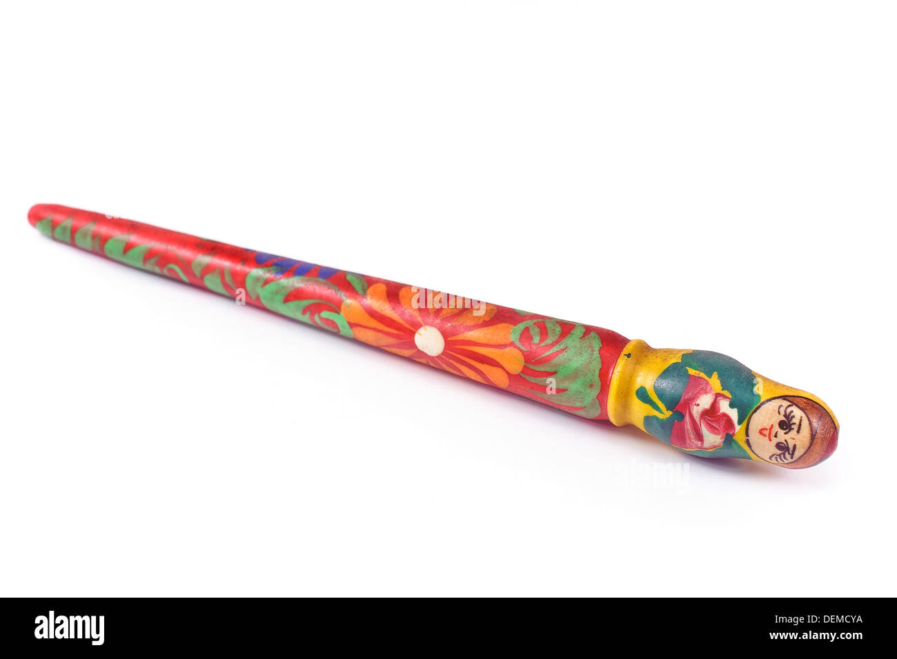Colorful wooden babushka stick isolated on white Stock Photo - Alamy