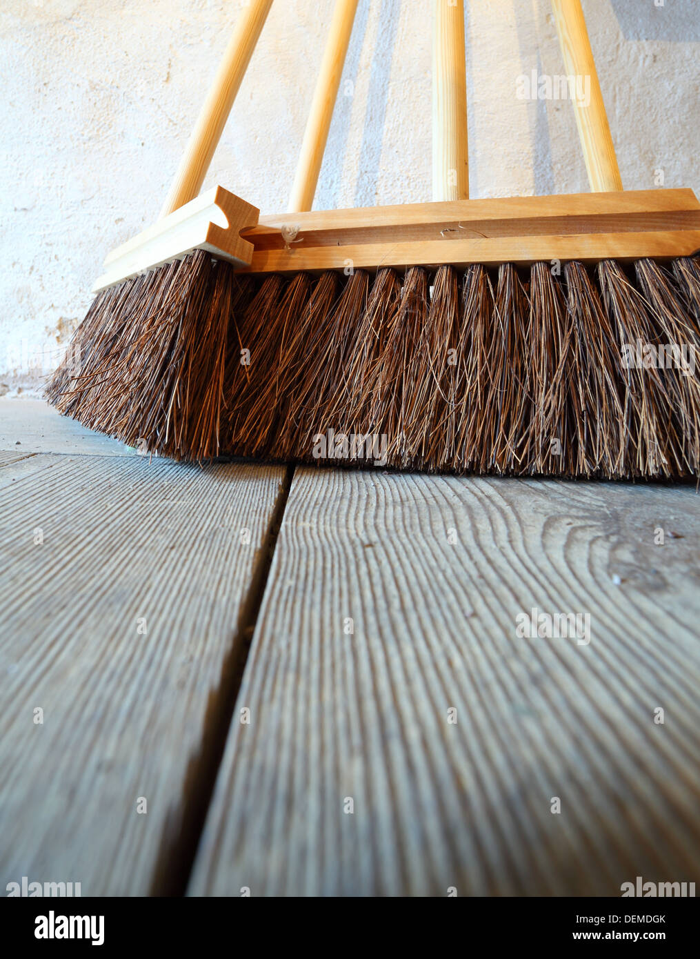 Close up large brooms for house work on old wooden floor of country ...