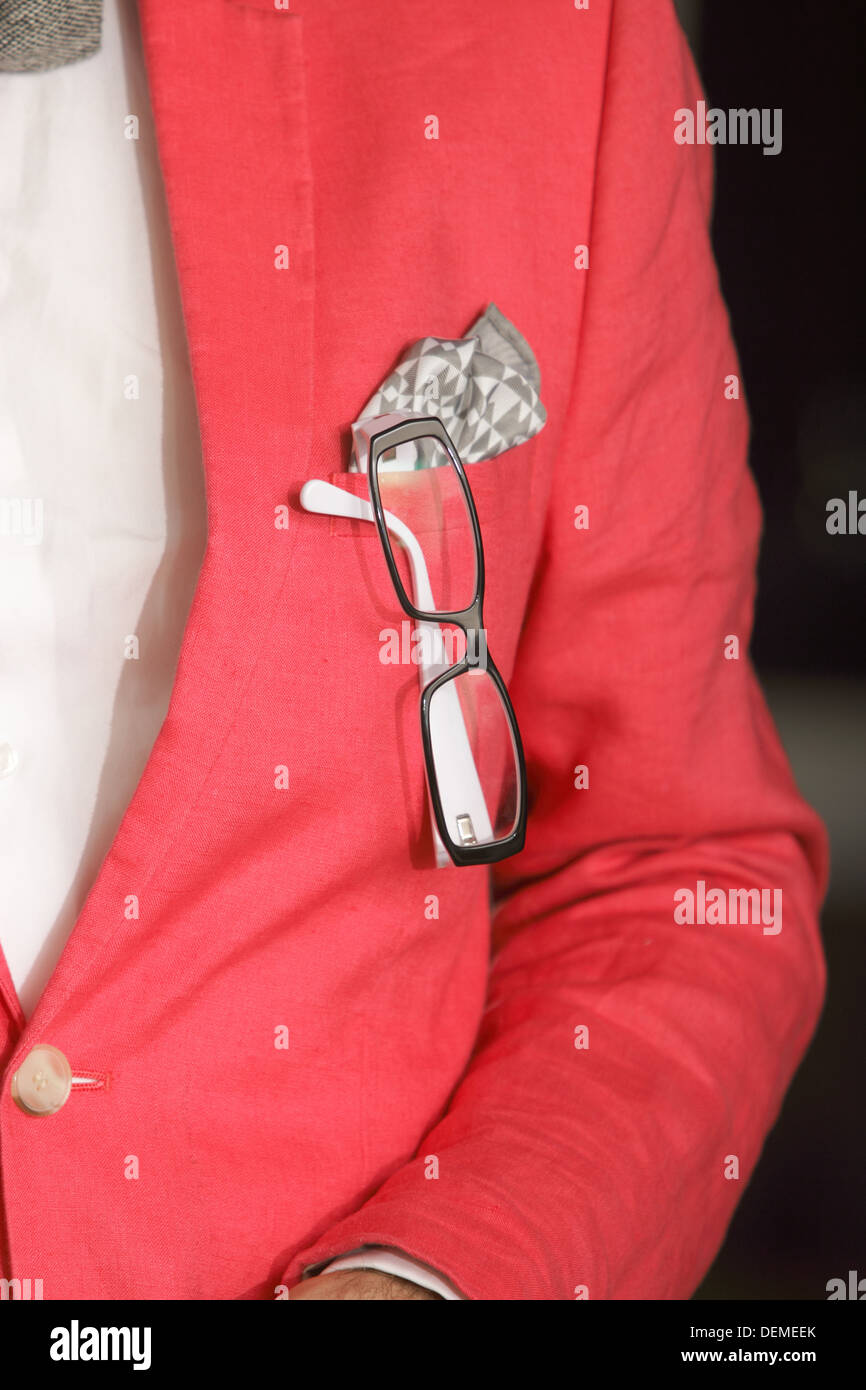 Red jacket handkerchief and glasses in his buttonhole Stock Photo - Alamy