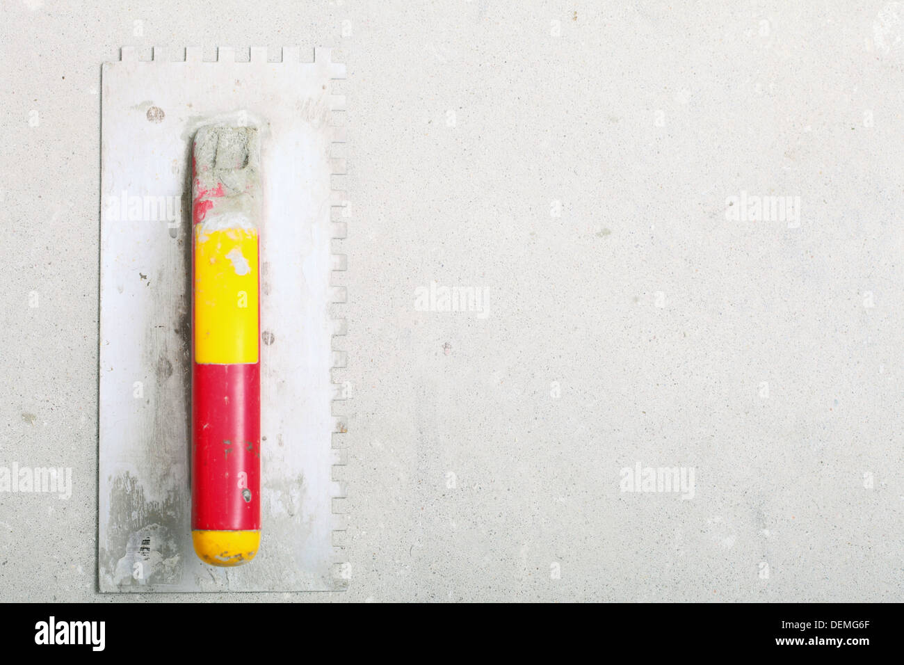 construction equipment dirty red yellow trowel used for masonry on ...