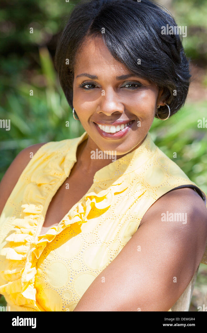 A beautiful happy middle aged African American woman relaxing and ...