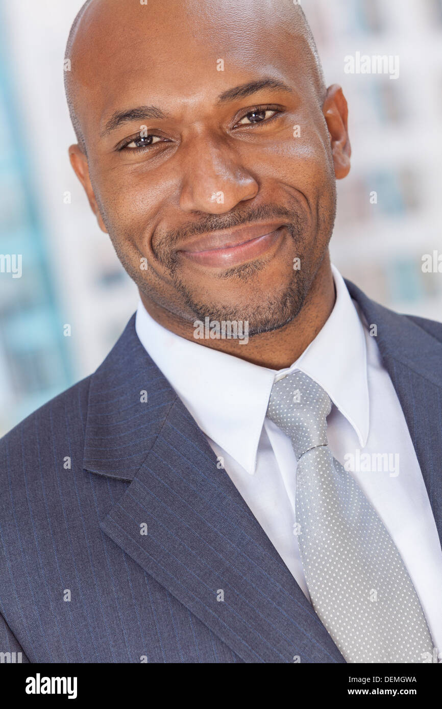 Happy smiling successful African American businessman or man in a suit ...