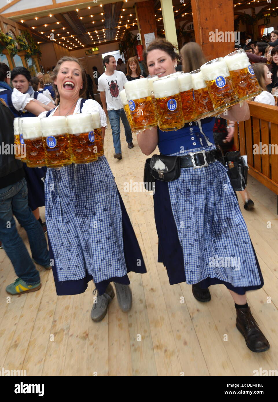 Munich, Germany. 21st Sep, 2013. Waitresses Mascha (L) and Helga carry ...