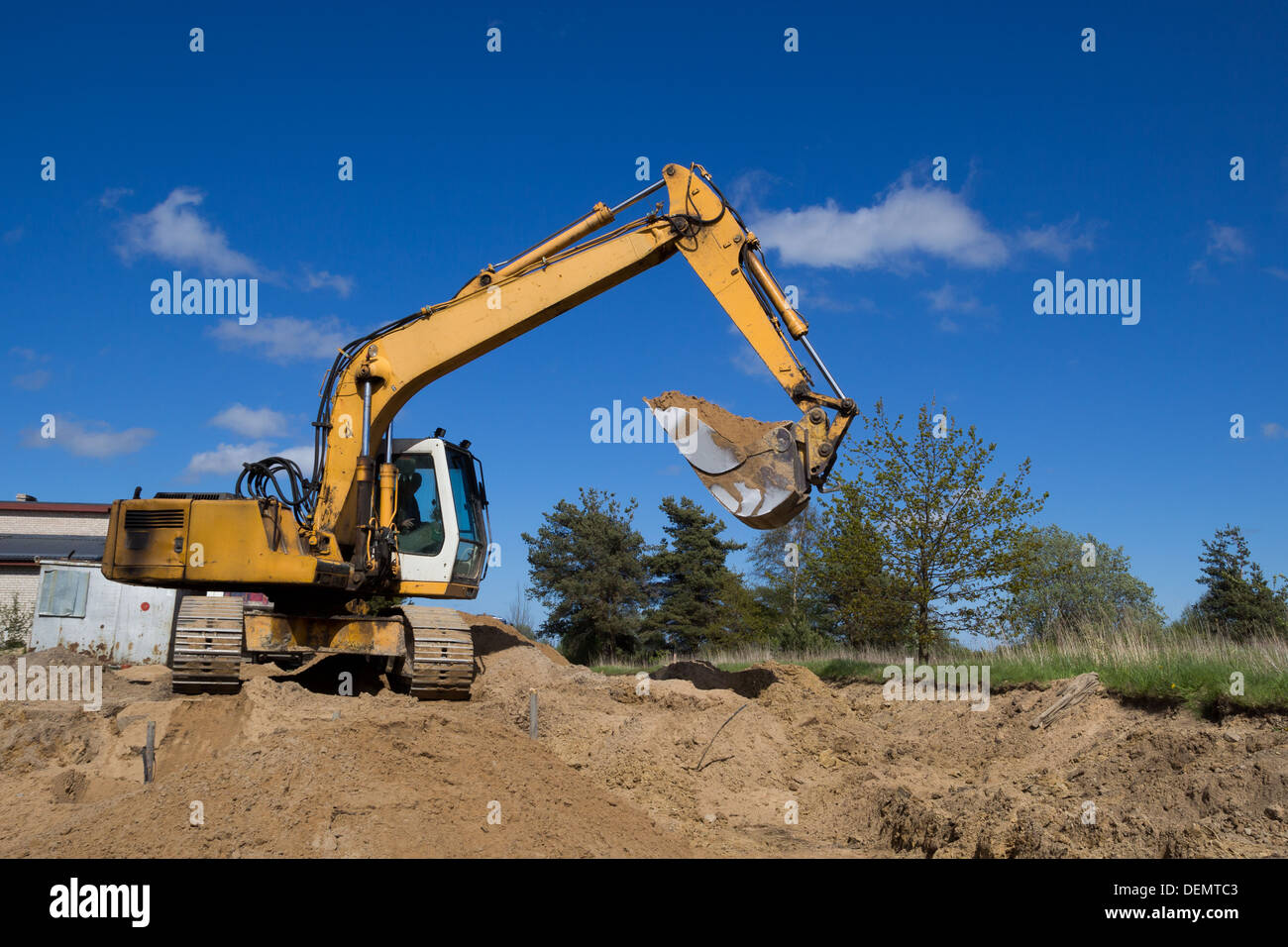 big yellow excavators working on a construction site Stock Photo - Alamy