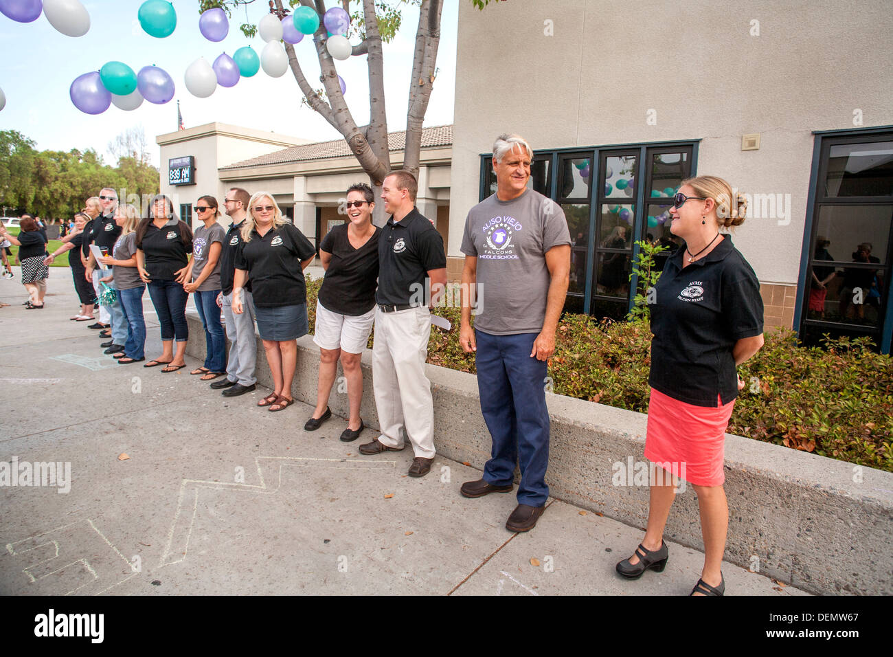 Faculty members line up to greet students on the first day of middle ...