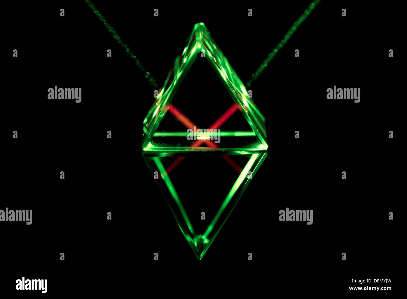 Green laser rays pass through and reflect inside the glass prism Stock ...