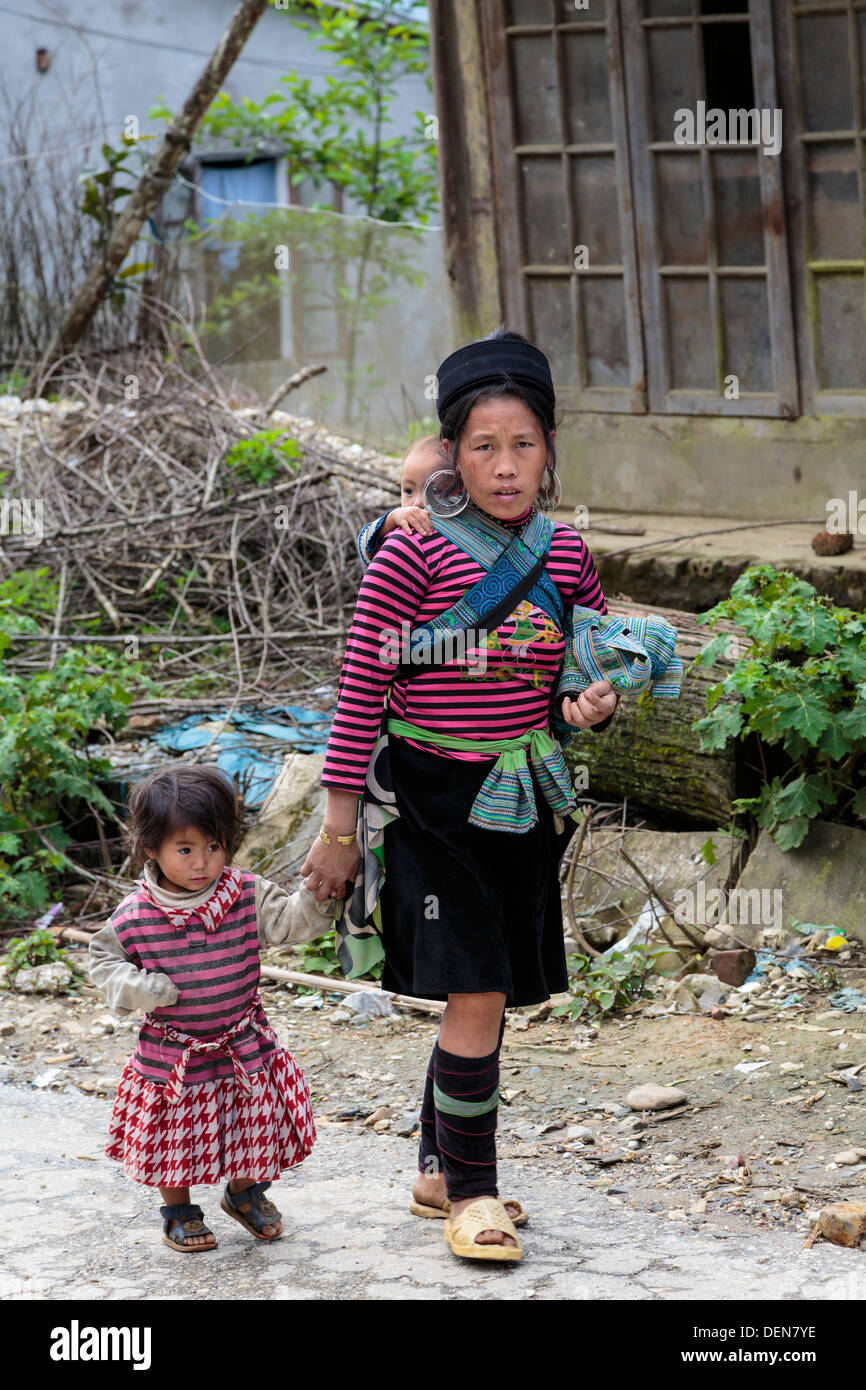 A Black Hmong mother and child on the street of Lao Chi village near ...