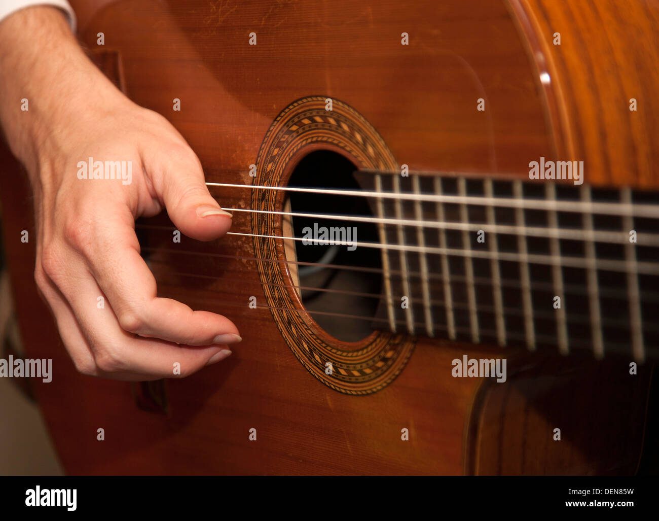 Close up acoustic guitar being played Stock Photo - Alamy