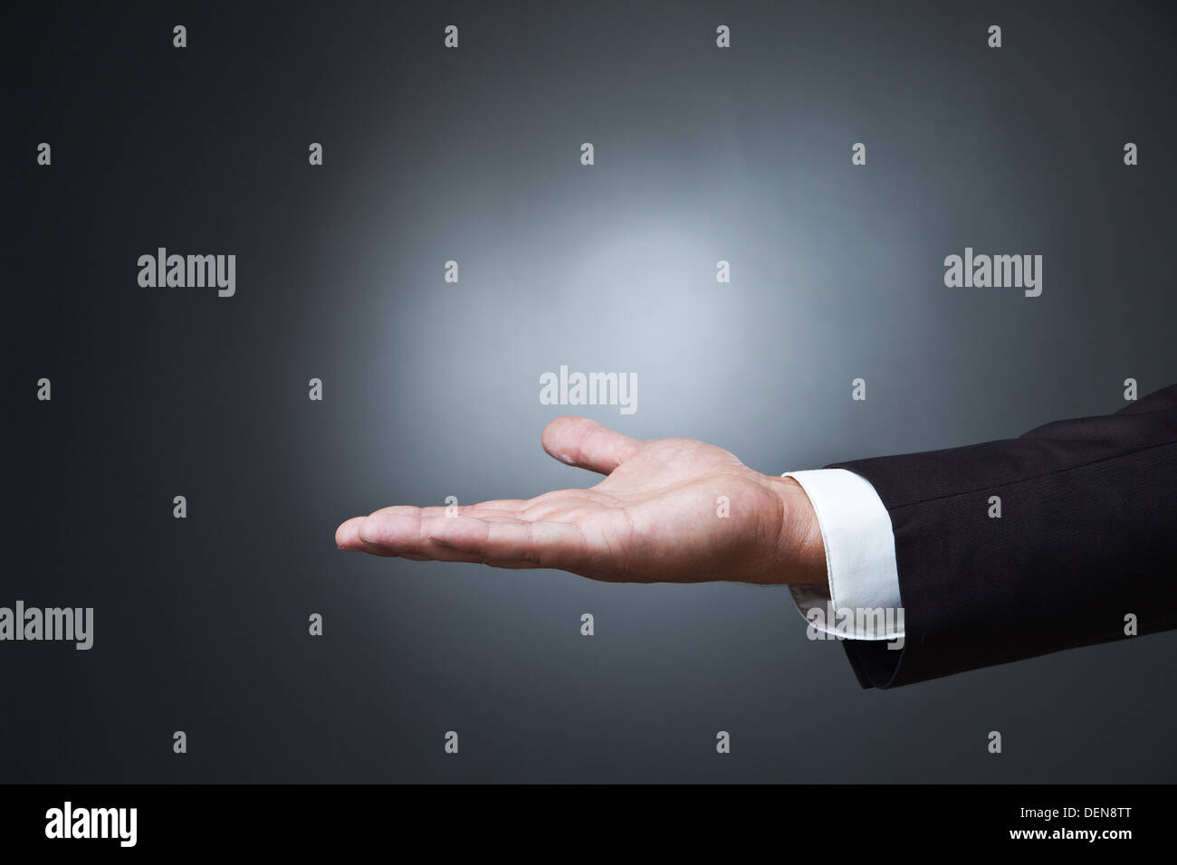 Open palm hand gesture of male hand on dark background Stock Photo - Alamy