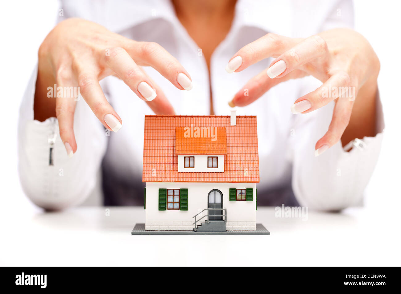Female hands and small house Stock Photo - Alamy