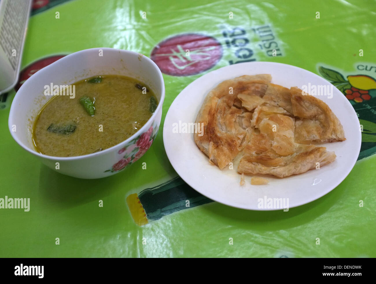 Bowl of green curry served with Thai-style roti in Bangkok, Thailand ...
