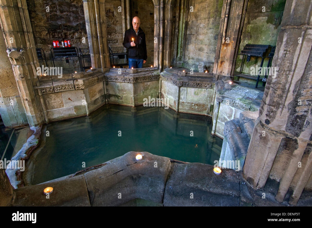 Pilgrims collecting or drinking water from the spring hi-res stock ...