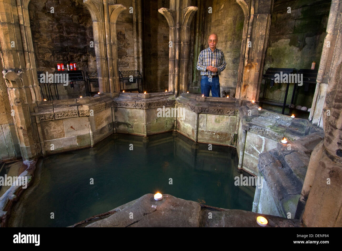 Pilgrims collecting or drinking water from the spring hi-res stock ...
