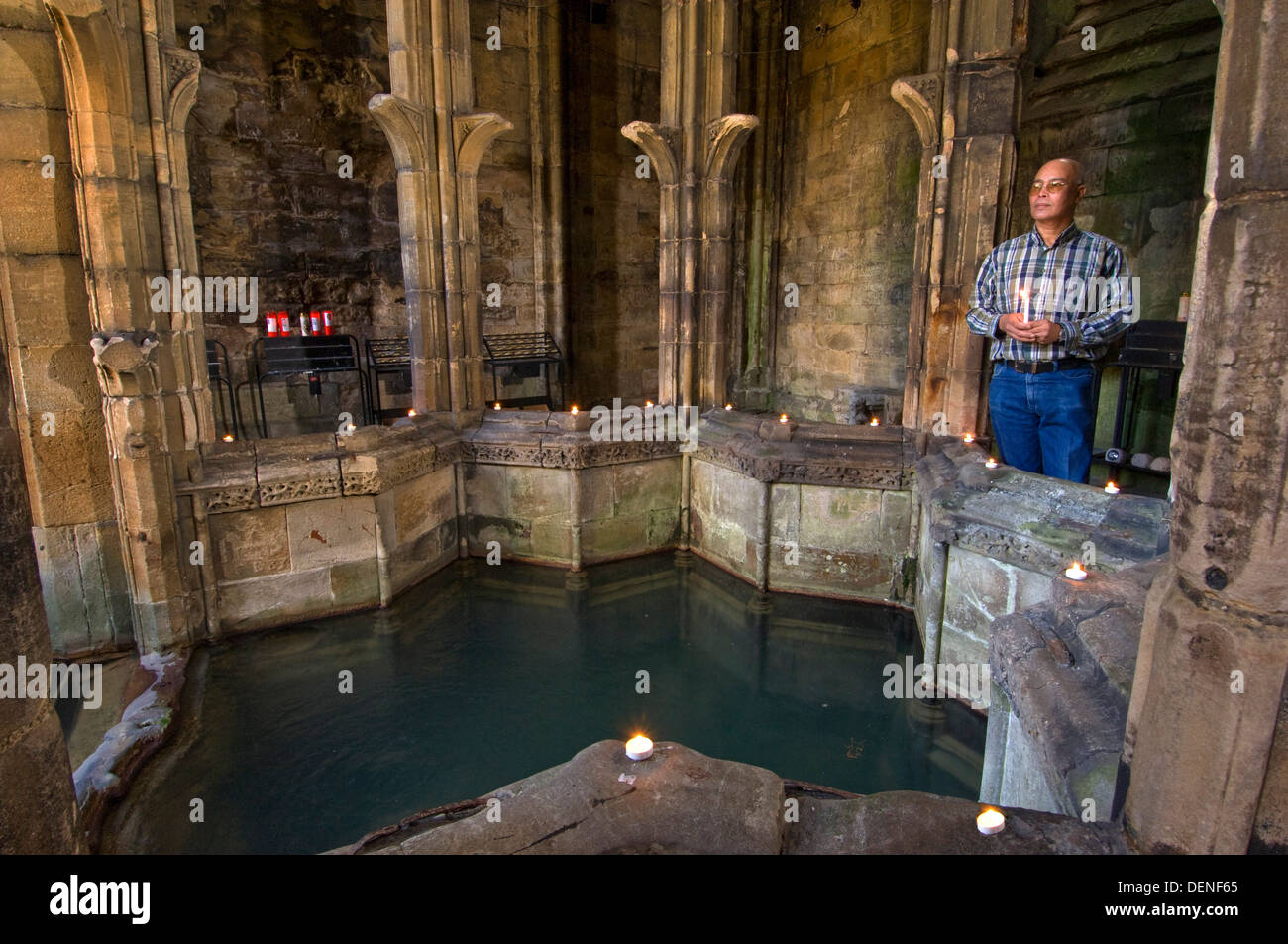 Pilgrims collecting or drinking water from the spring hi-res stock ...