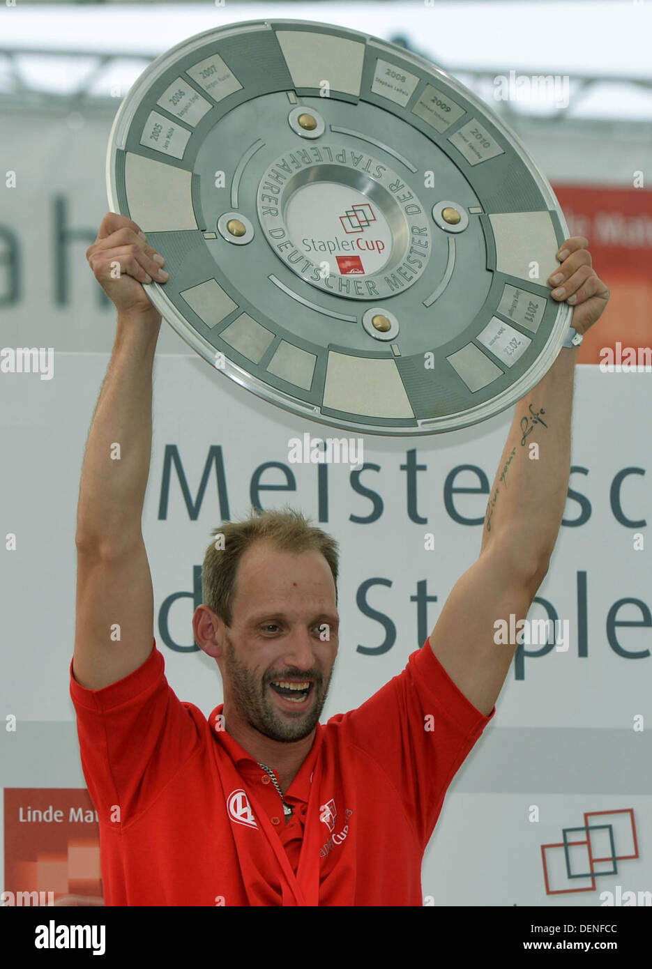 Winner of the German forklift truck championships Stefan Theissen holds ...