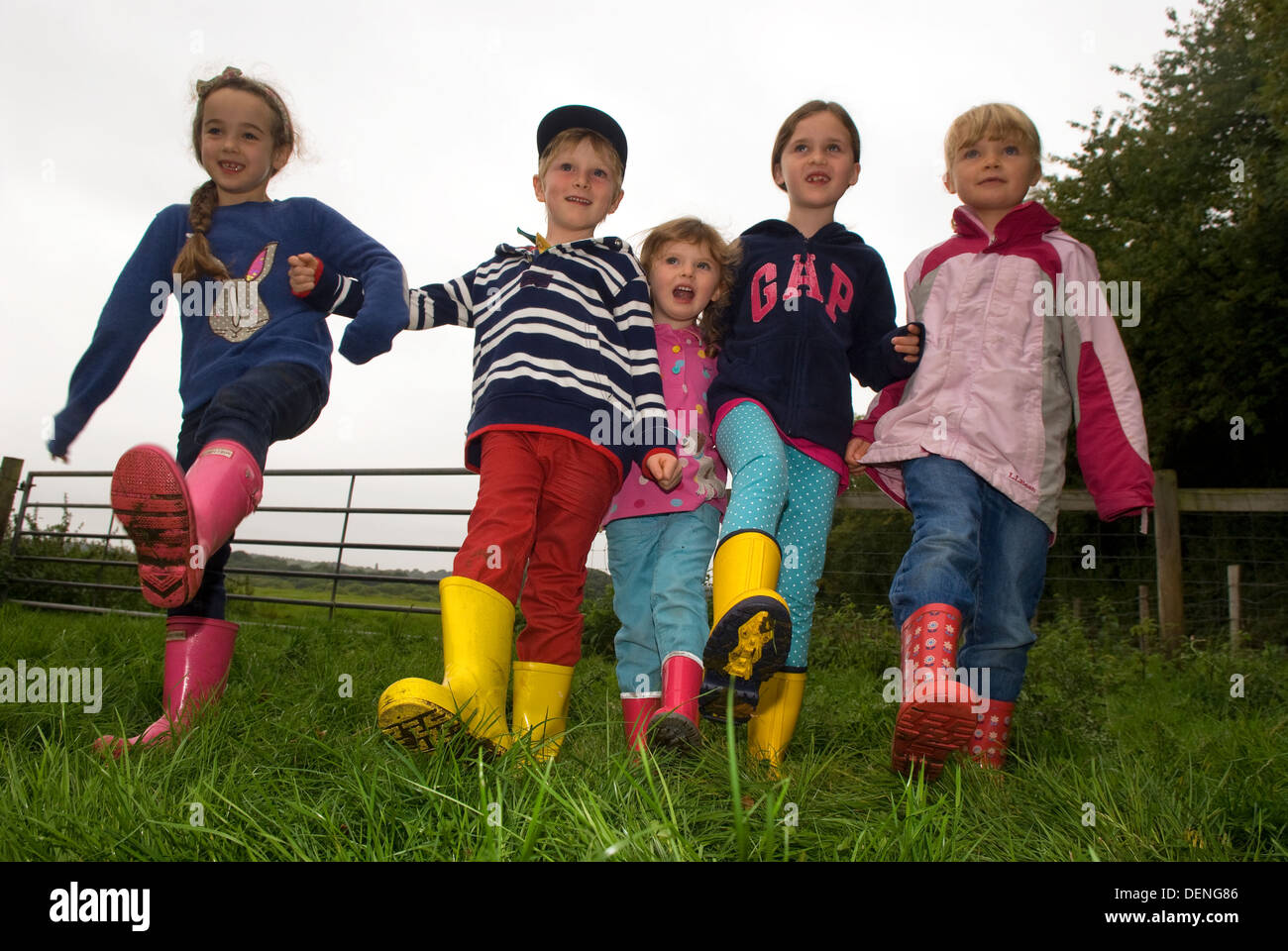 Group of youngsters larking around whilst on a countryside farm tour ...