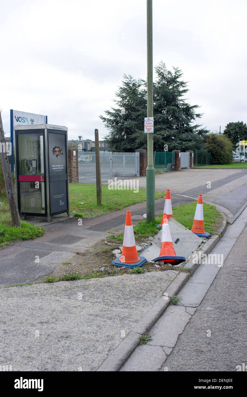 Traffic cones surrounding an inspection manhole with collapsed broken ...
