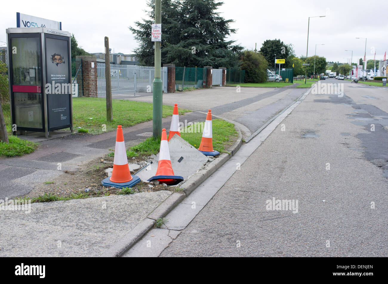 Traffic cones surrounding an inspection manhole with collapsed broken ...