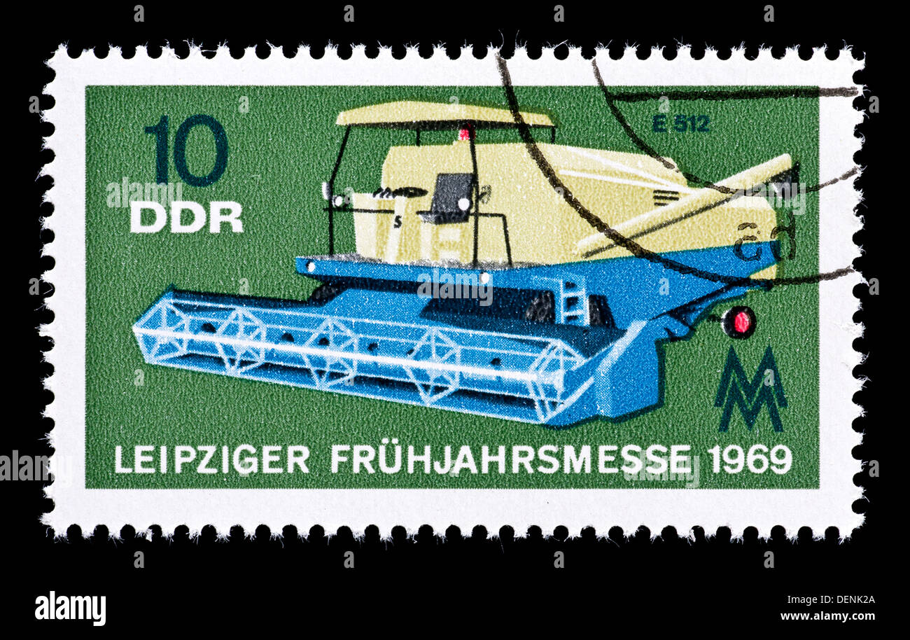 Postage stamp from East Germany (DDR) depicting a farm combine Stock Photo - Alamy