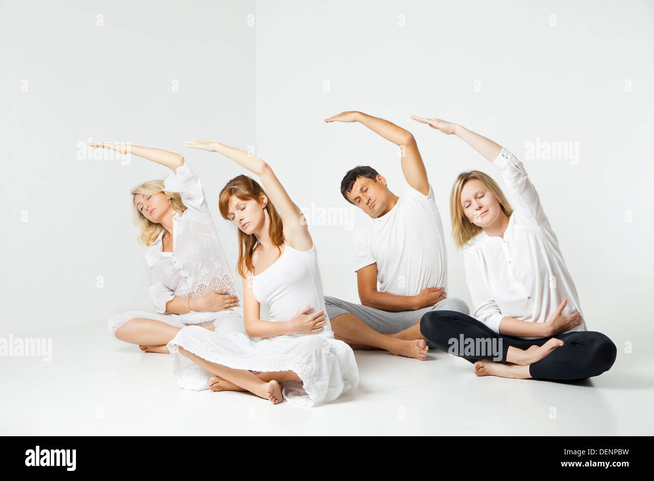 Group people relaxing doing yoga hi-res stock photography and images ...