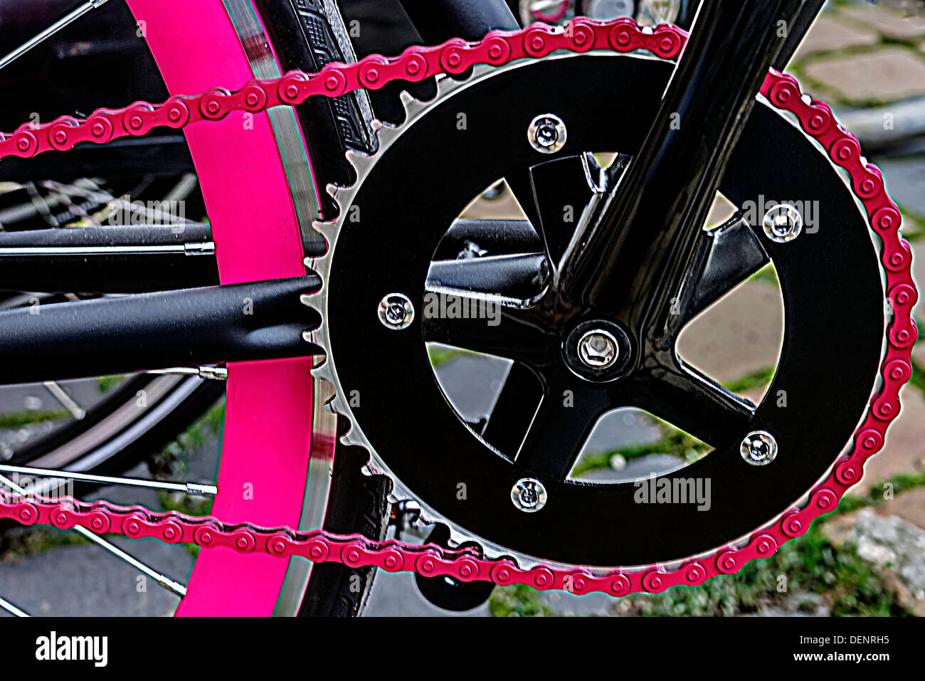 Detail of bicycle crank, red chain, derailleur and pink rear wheel ...