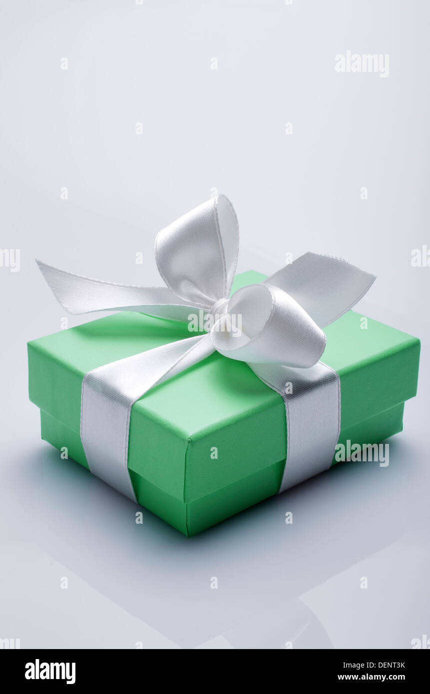 small green box tied with a white ribbon Stock Photo - Alamy