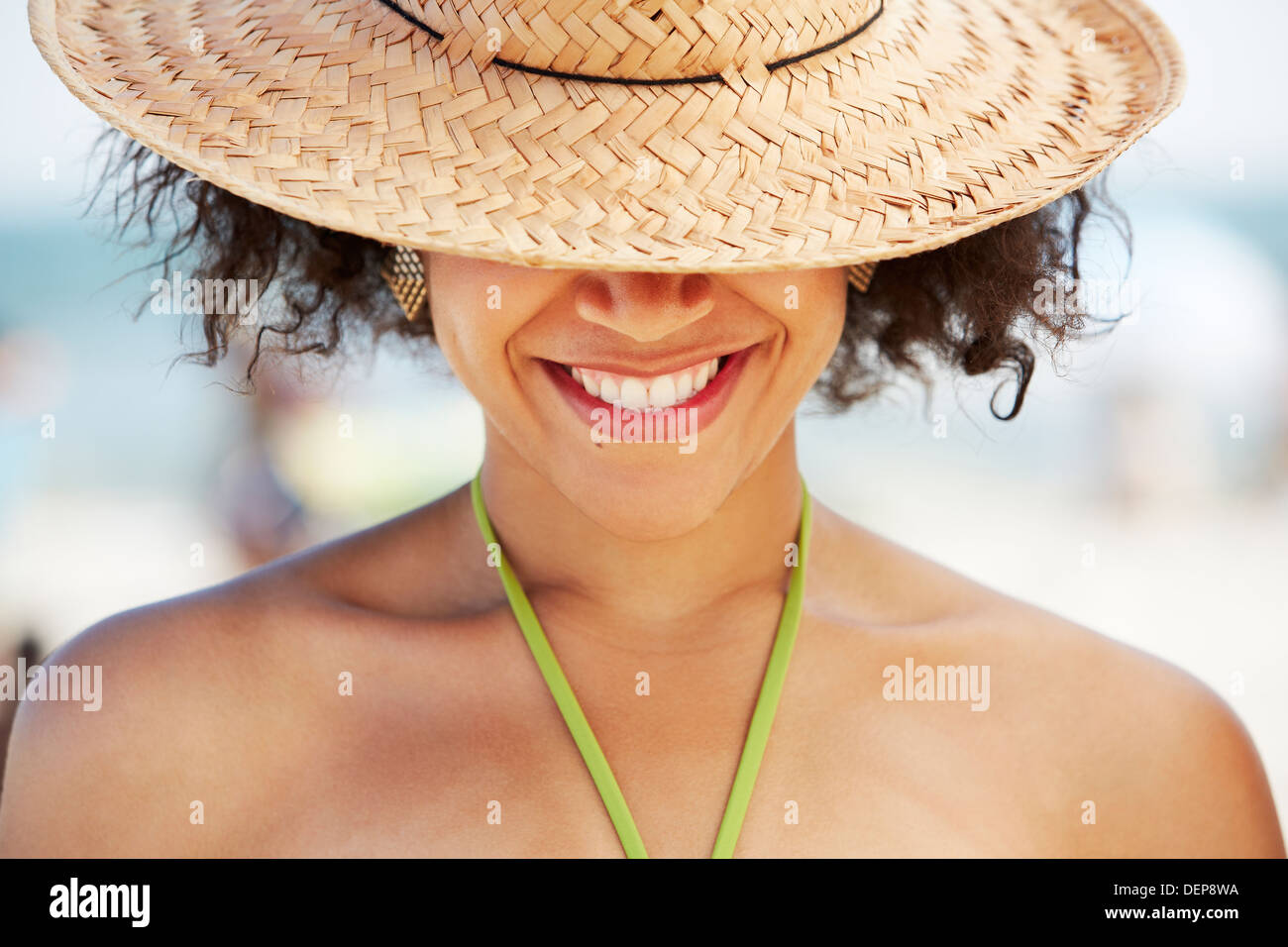Hispanic woman smiling on beach Stock Photo - Alamy