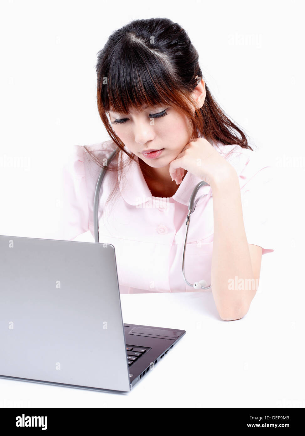 Nurse is tired of working with computer Stock Photo - Alamy