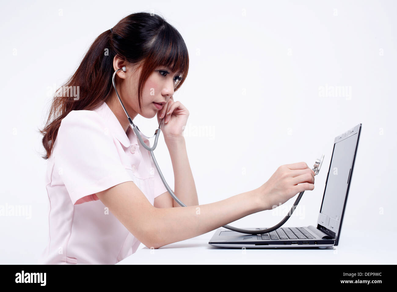 Nurse is checking computer by stethoscope Stock Photo - Alamy