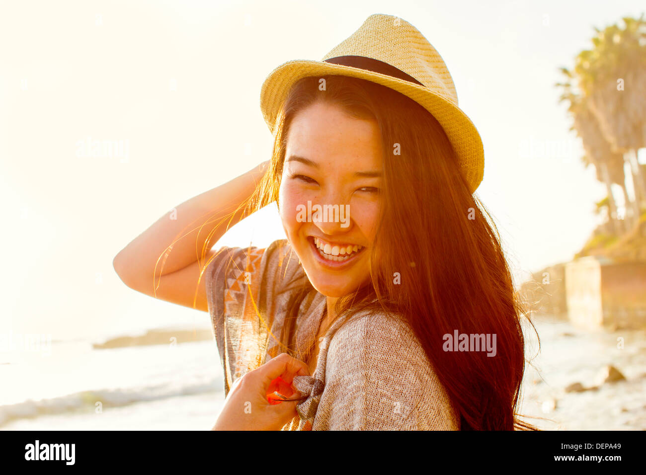Japanese woman smiling on beach Stock Photo - Alamy