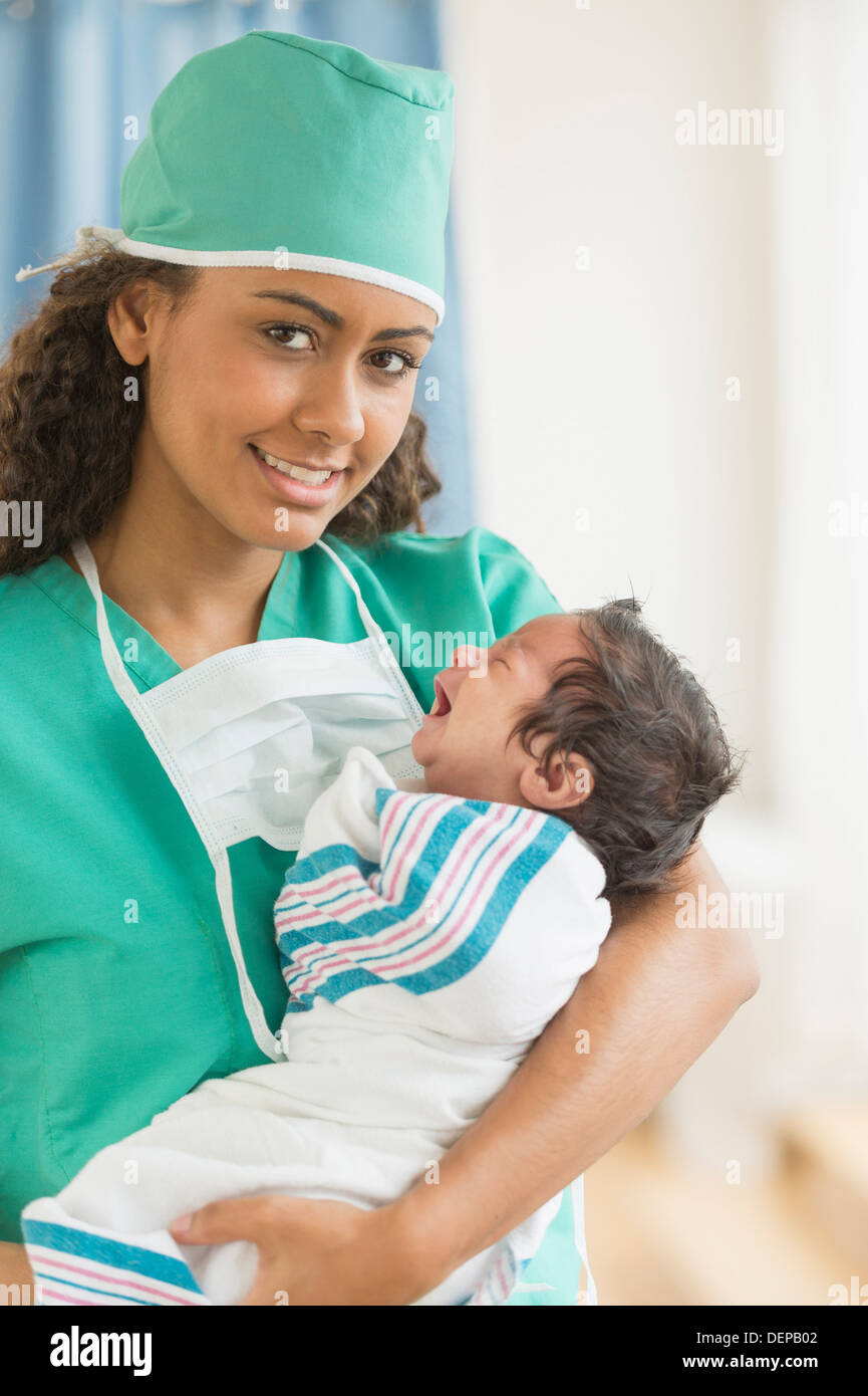 Nurse holding newborn baby hi-res stock photography and images - Alamy